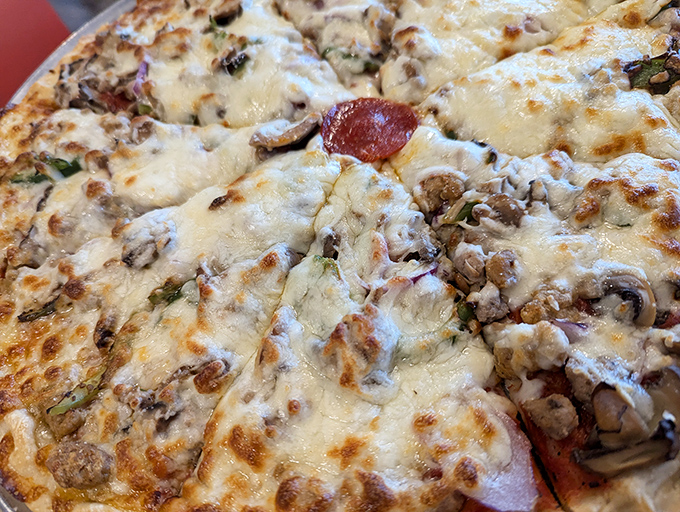 This isn't just pizza—it's edible artwork where cheese, meat, and mushrooms perform a beautiful dance of flavor on a perfect crust.