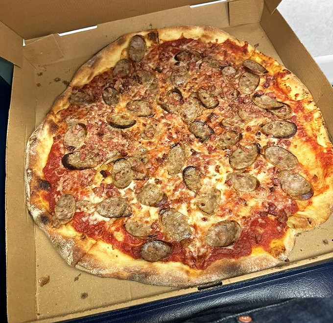 This sausage pizza isn't just food; it's edible architecture. The perfect ratio of crust to sauce to cheese to meat—a delicious equation solved.
