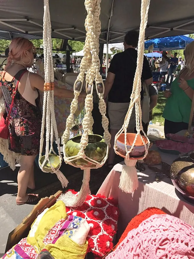 Macramé plant hangers swing gently in the summer breeze, bringing 1970s bohemian vibes back with a vengeance that would make your grandma proud.