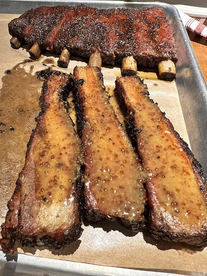 These pork spare ribs glisten like edible jewelry, each bone a treasure chest of smoky, succulent perfection.