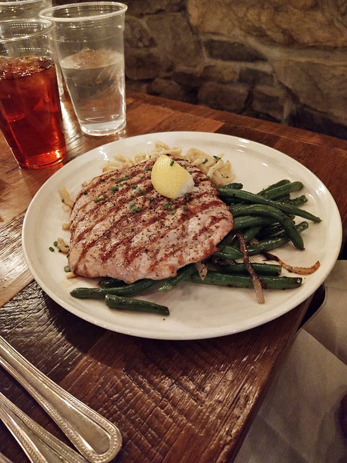A perfectly grilled pork cutlet rests alongside vibrant green beans—proof that German cuisine isn't all about heaviness, though I wouldn't call it diet food either.