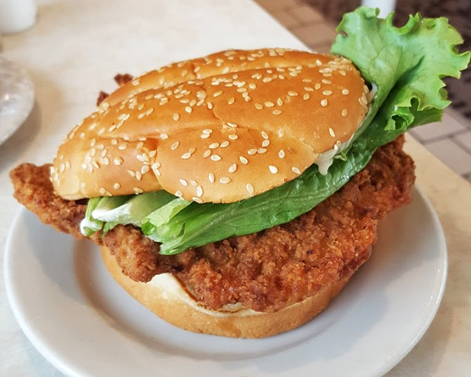 The legendary breaded pork tenderloin sandwich—where the meat requires its own zip code and the bun seems to be playing a supporting role at best.