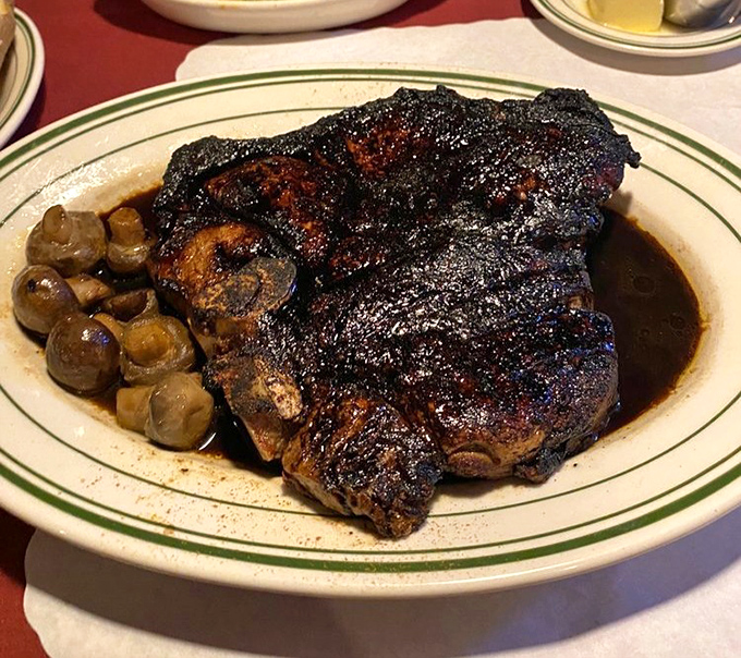 Behold the star of the show—a perfectly seared porterhouse with mushrooms that have found their life's purpose as steak companions.