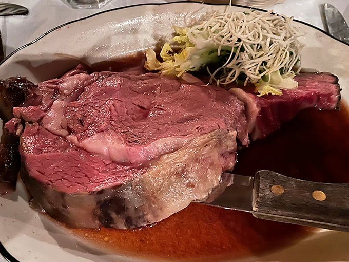 The prime rib arrives like a carnivore's dream painting—perfectly pink, glistening with jus, and generous enough to make your cardiologist wince.