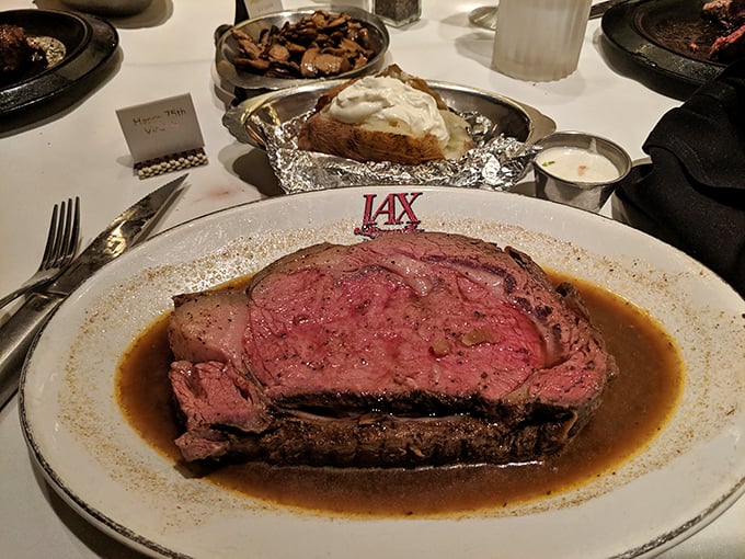 Behold the prime rib in its natural habitat—swimming in au jus, perfectly pink, and making every other dinner decision you've ever made seem questionable.