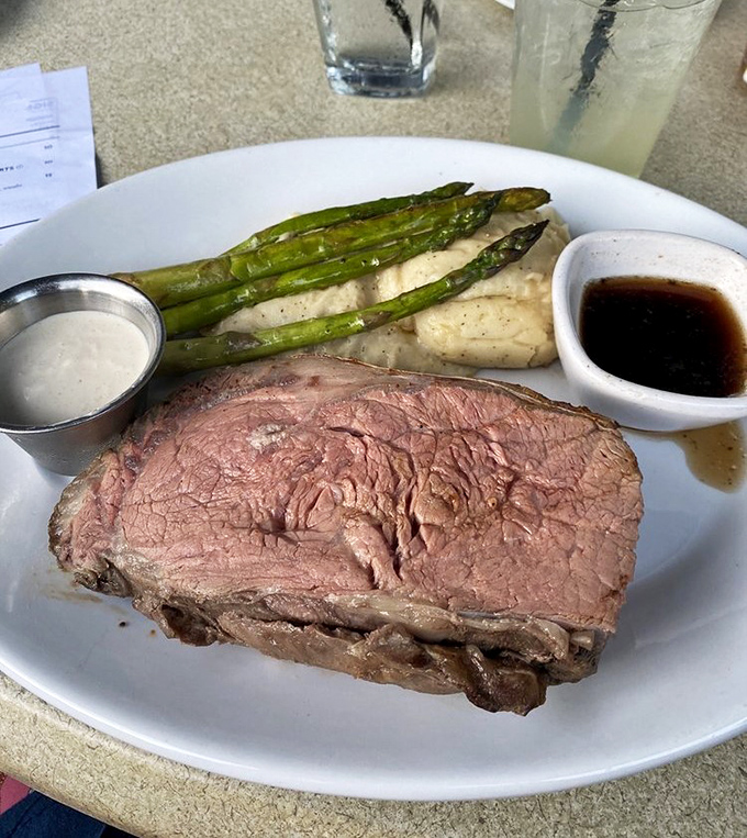 The prime rib doesn't just speak for itself—it sings a full-throated aria of beefy perfection, accompanied by asparagus and that magical au jus.