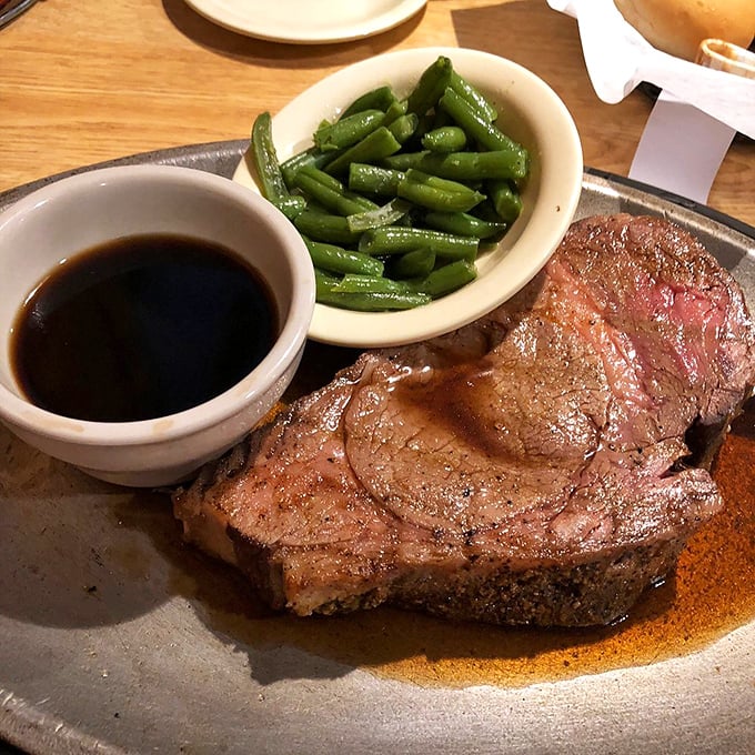 A perfectly cooked steak with green beans and au jus – simple perfection that proves fancy plating is overrated when flavor does the talking.
