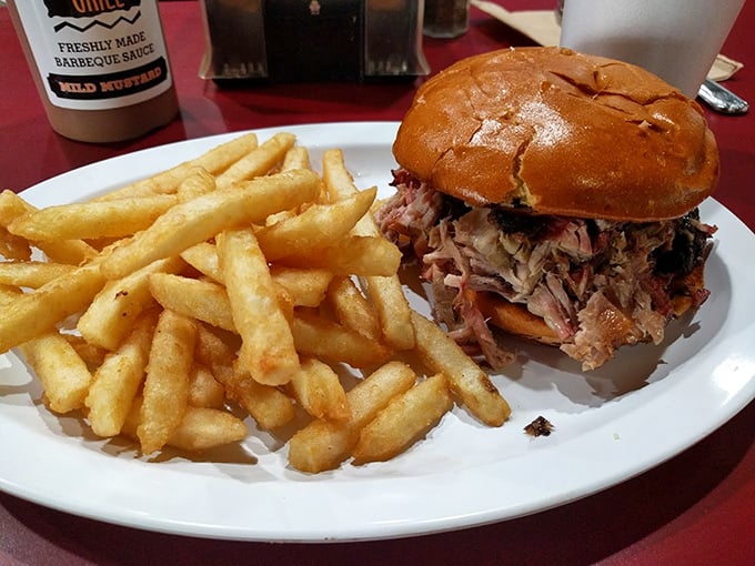The legendary pulled pork sandwich arrives like a celebrity in disguise – humble in appearance but causing spontaneous eye-closing with each bite.