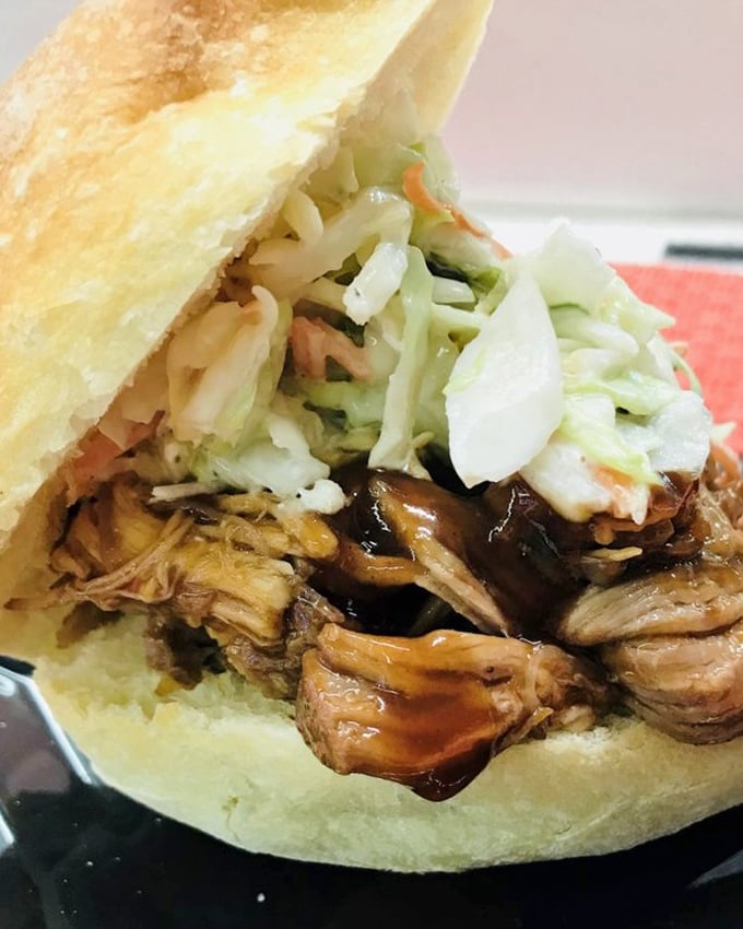 This pulled pork sandwich isn't just topped with coleslaw—it's crowned with it. Royalty among lunch options.
