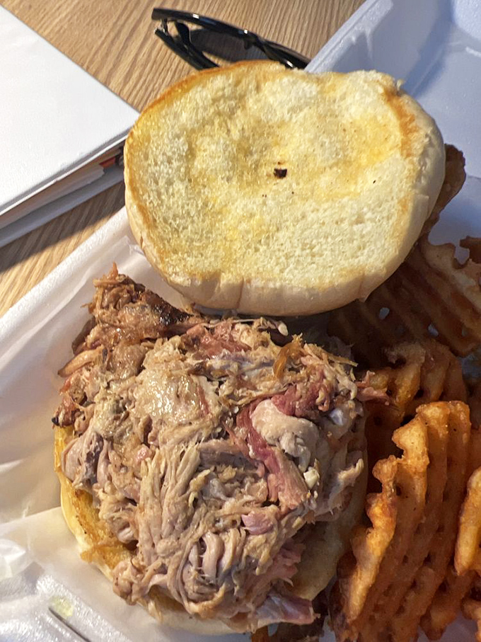 Pulled pork piled higher than your weekend to-do list, nestled between golden Texas toast. This sandwich doesn't need a resume—it speaks for itself.