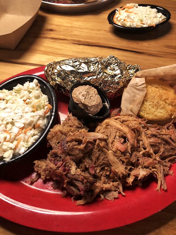 This pulled pork plate isn't just dinner—it's what happens when meat meets patience, smoke, and a pitmaster who understands the importance of both.