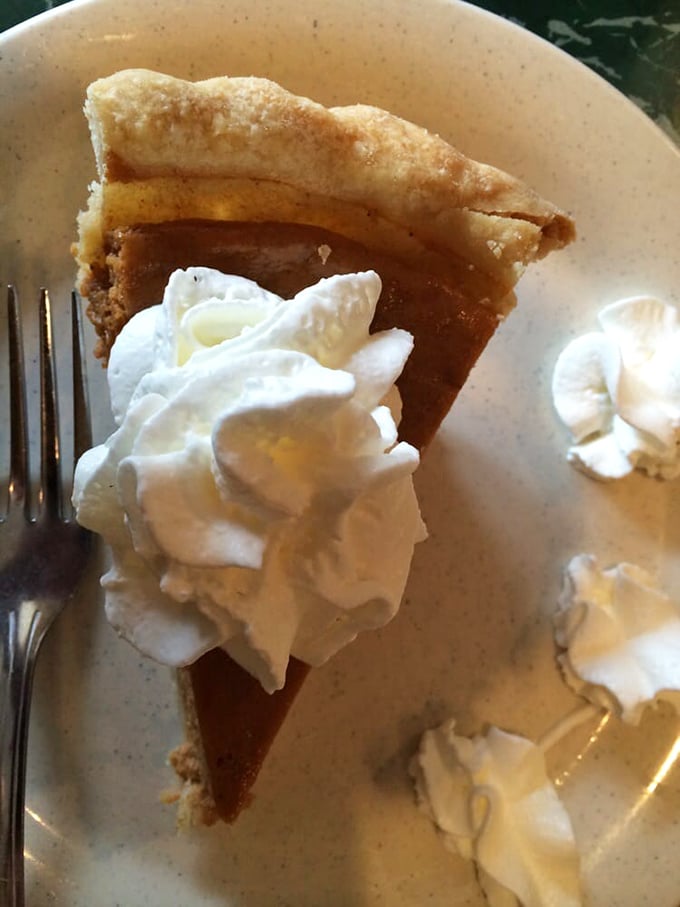 Pumpkin pie with clouds of whipped cream—the kind that makes you close your eyes on first bite and momentarily forget your table manners.