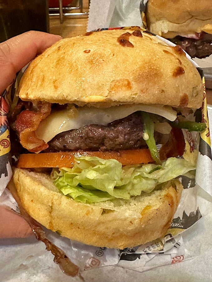 Architectural perfection between two buns. This isn't just a burger—it's edible engineering with bacon as the structural support.