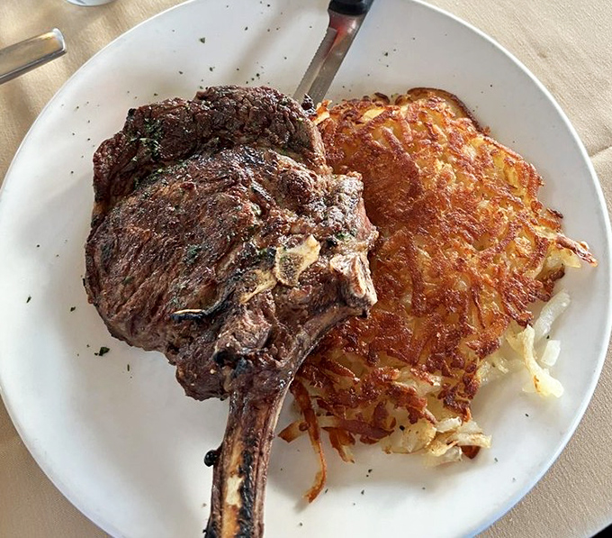 Behold the bone-in ribeye with golden hash browns—a duo so perfect they should tour together like Simon and Garfunkel.