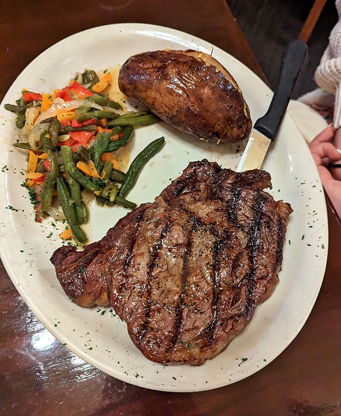 Behold the star of the show—a perfectly seared ribeye with textbook grill marks that whisper, "This is why you drove all this way."