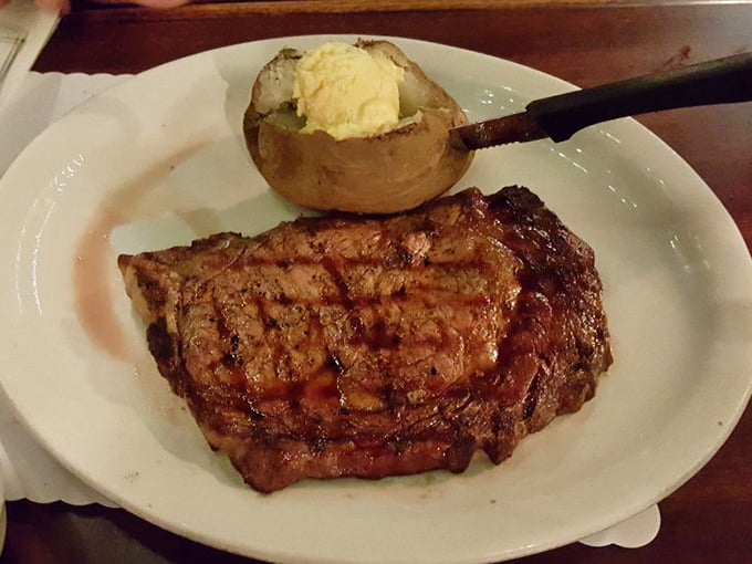 A perfectly grilled steak and loaded baked potato—the Fred Astaire and Ginger Rogers of classic American dining, dancing together in carnivorous harmony.