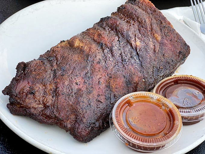 These ribs don't just fall off the bone—they practically leap onto your fork with a perfect bark that's the barbecue equivalent of winning the lottery.