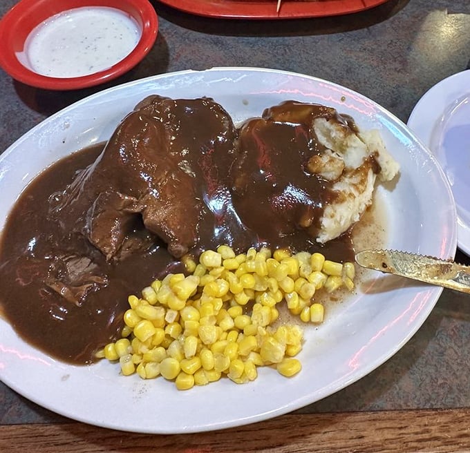 This isn't just roast beef – it's a brown gravy symphony with mashed potato backup singers and corn that's clearly happy to be part of the ensemble.