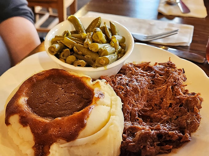 Behold the star attraction: fork-tender roast beef swimming in savory gravy alongside creamy mashed potatoes. Grandma would approve—and ask for seconds.