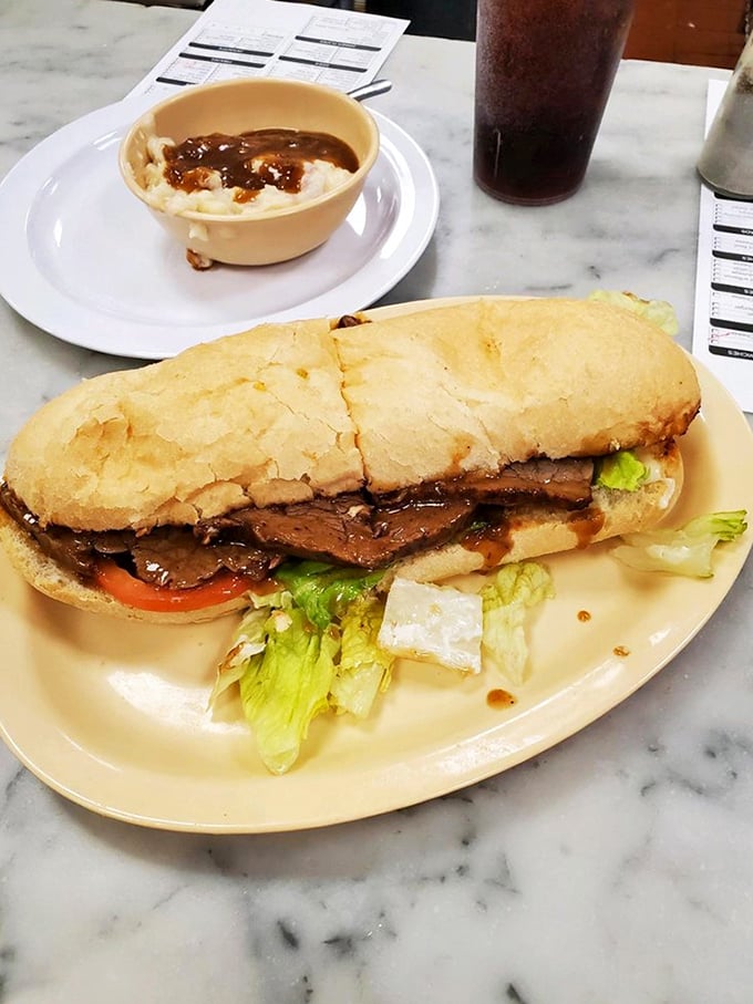 That's not just a roast beef po'boy—it's a masterclass in sandwich architecture where gravy meets French bread in a beautiful, messy romance.