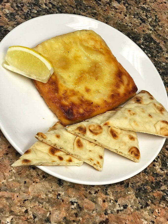 Saganaki: where cheese meets fire in a dramatic tableside performance that puts most Broadway shows to shame.