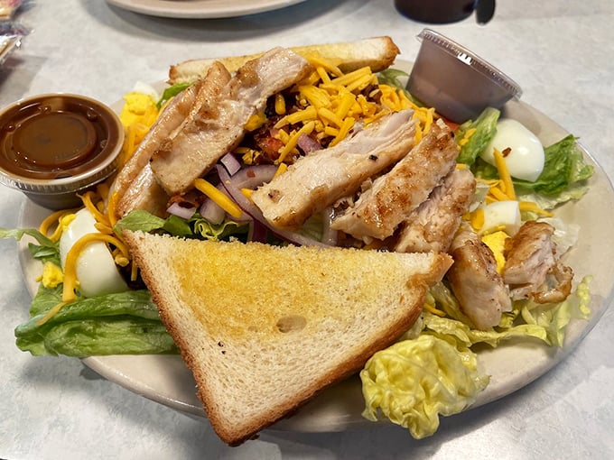 This isn't just a salad – it's a carefully orchestrated symphony of fresh ingredients topped with grilled chicken that would make even salad skeptics reconsider their life choices.