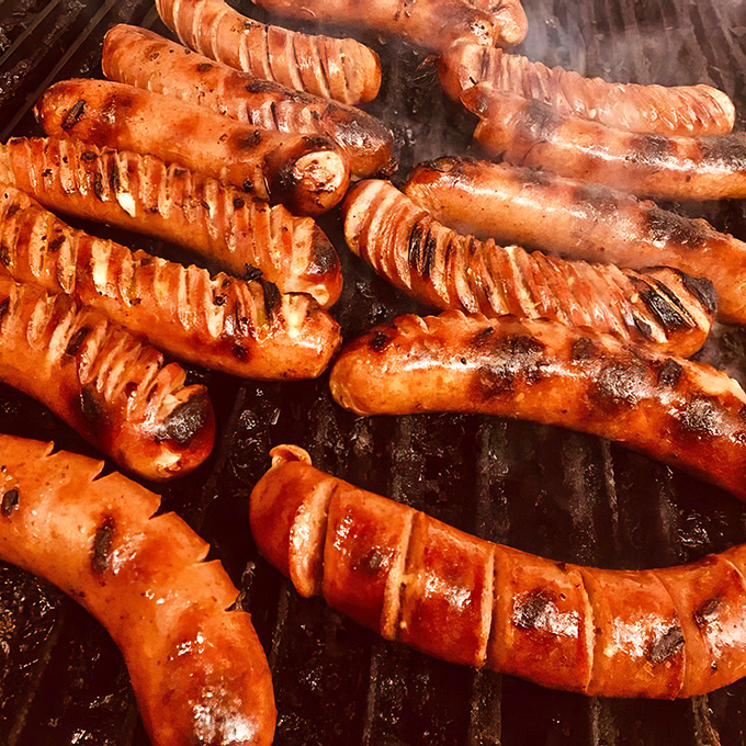 These sausages aren't just cooked, they're transformed – each grill mark a badge of honor in the quest for barbecue perfection.