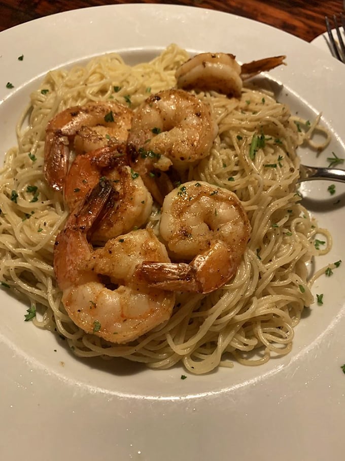 Shrimp scampi that makes you question every other version you've ever had—plump Gulf shrimp lounging in buttery garlic sauce like they own the place.