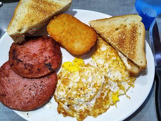 Breakfast perfection on a plate – golden eggs, crispy scrapple, and toast that's achieved that magical butter-to-crunch ratio that haunts your dreams.
