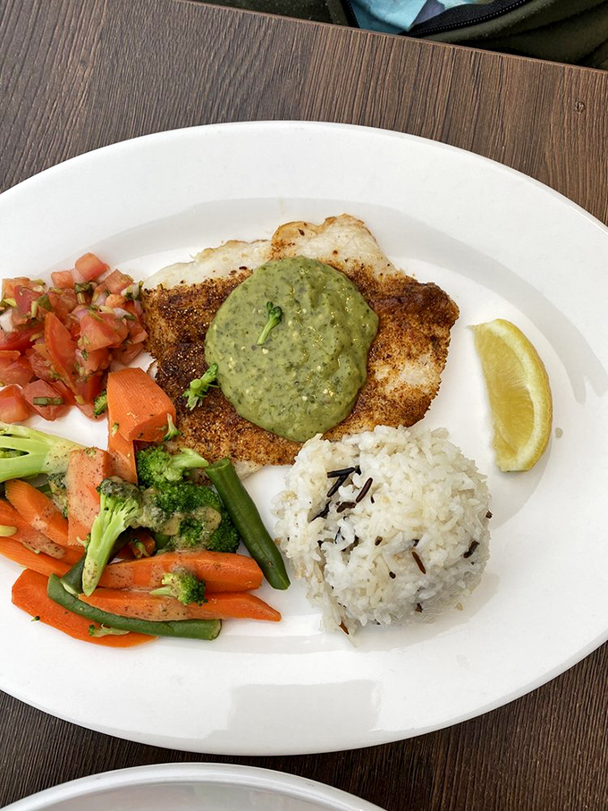 This isn't just fish – it's an experience. Perfectly seasoned, expertly cooked, and presented with colorful vegetables and rice that aren't mere afterthoughts.