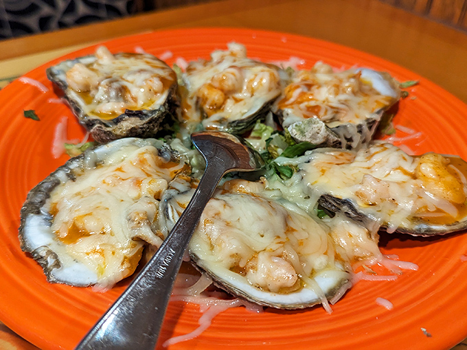 These oysters aren't just baked—they're transformed into little volcanic islands of cheese and seafood that erupt with flavor when your fork hits.