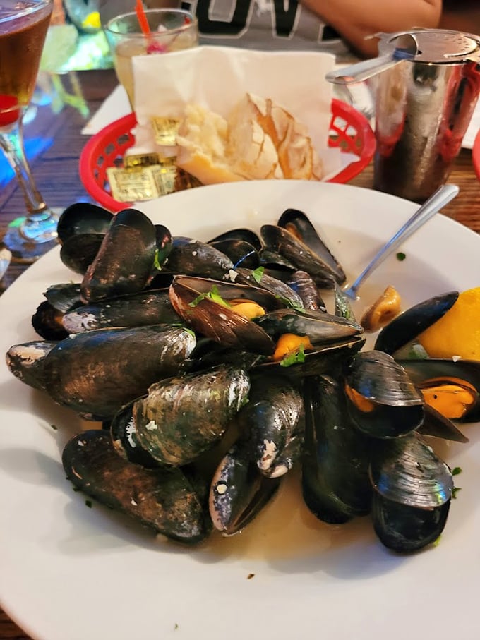 These mussels aren't just served—they're presented like oceanic jewels. Each shell opens to reveal a treasure that would make Neptune himself jealous.