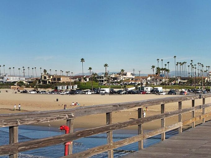 The Seal Beach Pier stretches toward the horizon like a wooden runway, inviting visitors to stroll above the gentle Pacific swells.