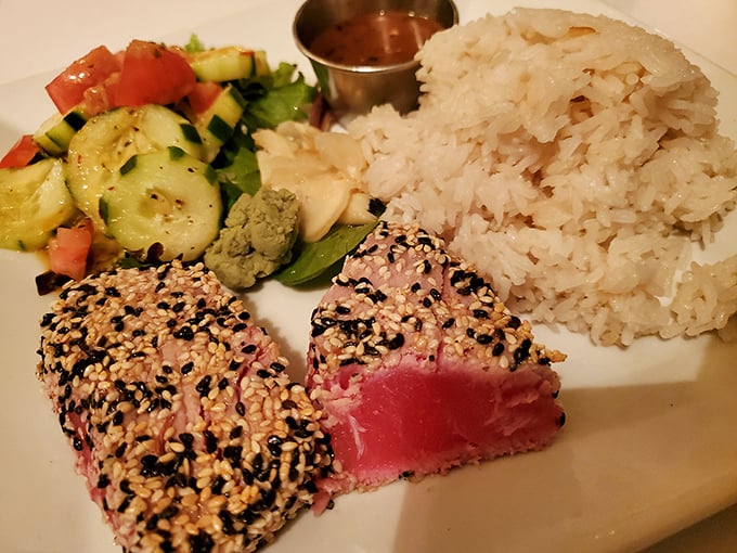 The legendary sesame-crusted tuna arrives like edible art—ruby-red center, crunchy seed coating, and sides that know their supporting role.