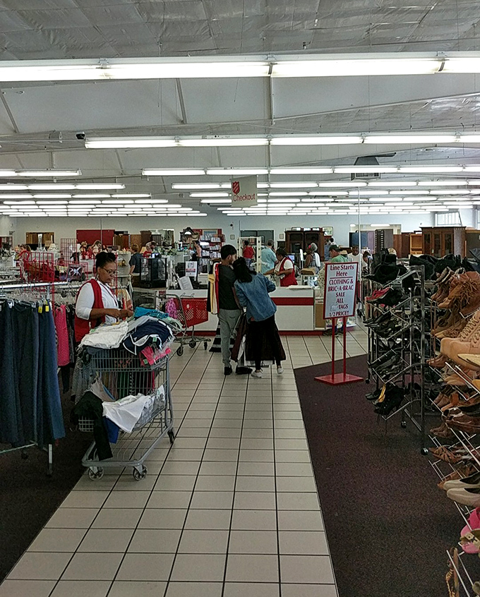 Thrift store rush hour—where savvy shoppers know the early bird gets the vintage worm. Notice the shopping carts already filling with potential treasures.