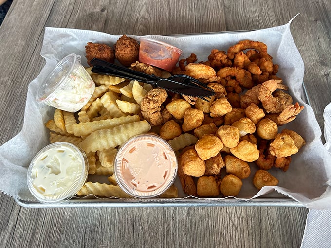 Golden-fried treasures from the sea nestled alongside crispy fries – proof that sometimes the simplest pleasures come in paper-lined baskets with little plastic cups of sauce.