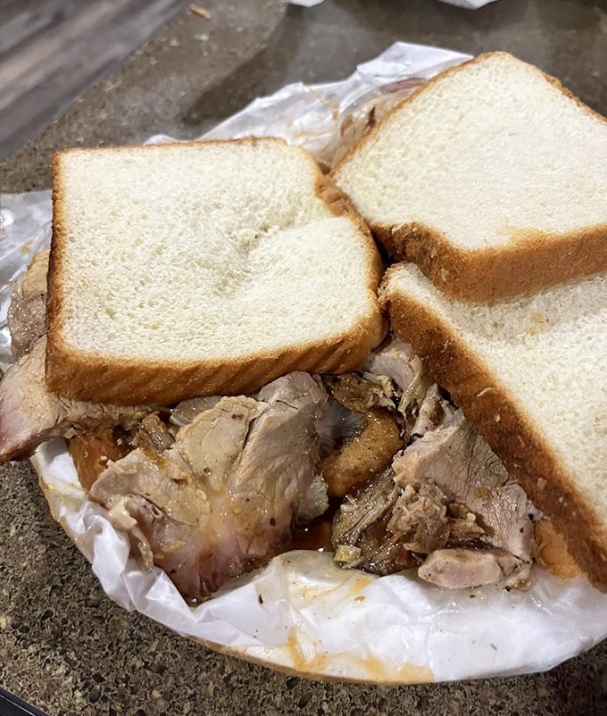 Actual slices of pork nestled between white bread—this is barbecue that respects both tradition and your taste buds.