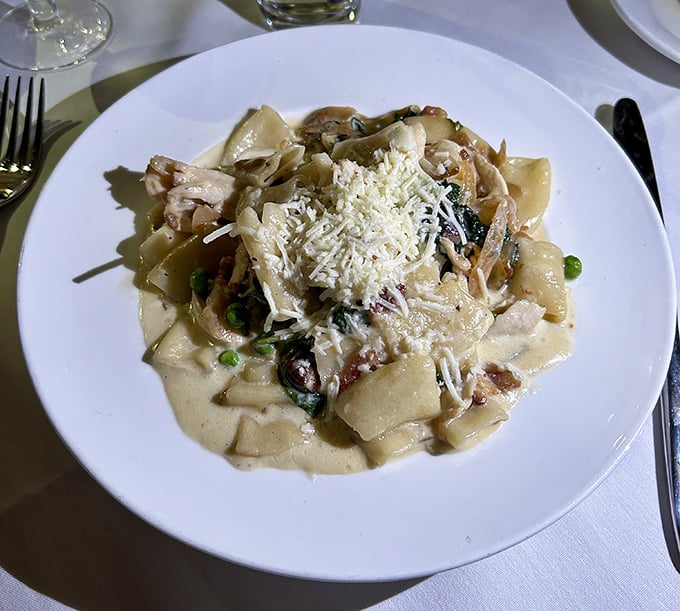 Behold the legendary Smoked Chicken Rigatoni in all its glory – pasta tubes swimming in creamy sauce with tender chicken and bright green peas.
