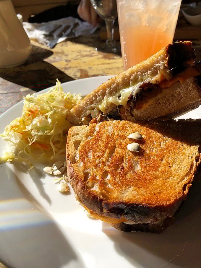 That golden-brown sourdough isn't just toast—it's the supporting actor that steals the show, with seeds adding texture to an already perfect canvas.