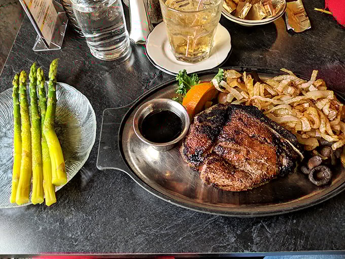 Behold the star of the show: a perfectly seared steak with asparagus standing at attention. This isn't dinner—it's edible artwork.