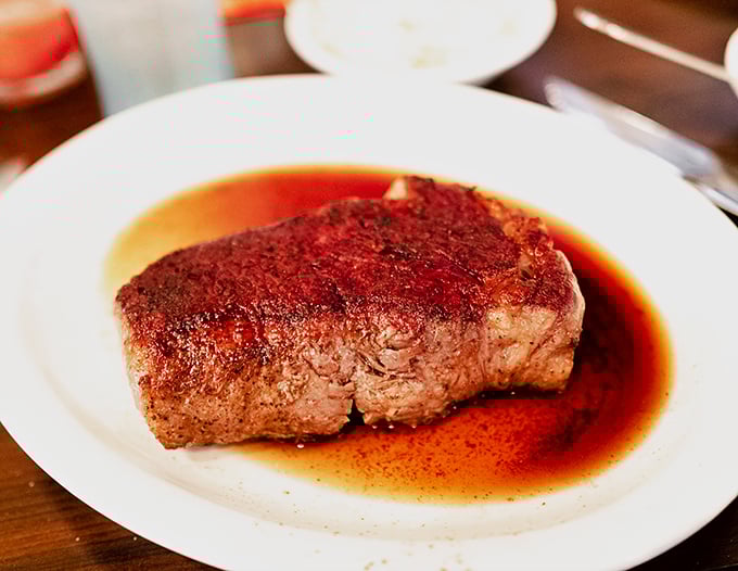 This isn't just a steak—it's a sermon on simplicity. Perfect sear, rosy interior, and a pool of jus that demands to be sopped up.