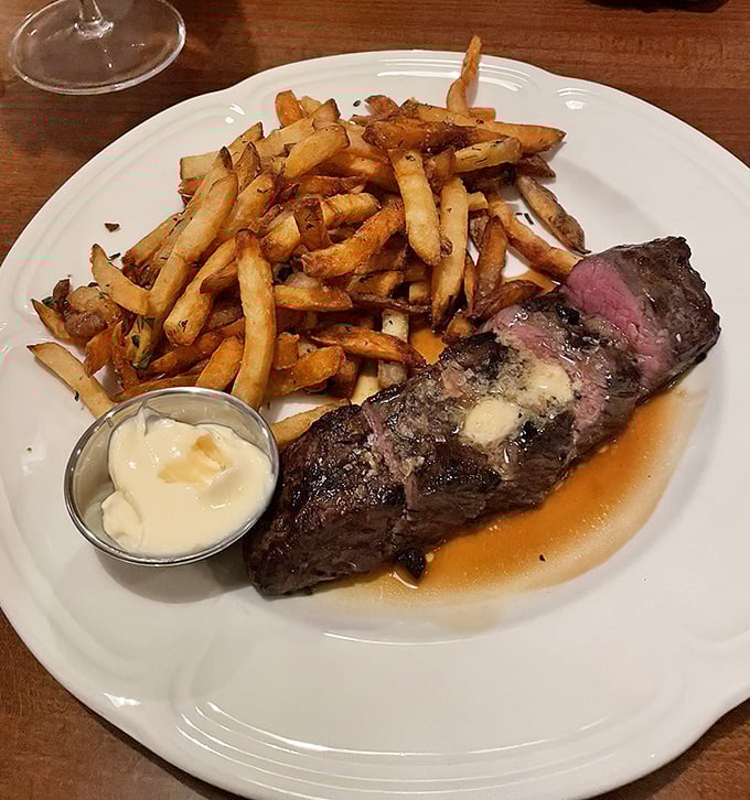 Behold the steak frites in all its glory: perfectly seared beef, impossibly crispy fries, and that little pot of aioli magic.