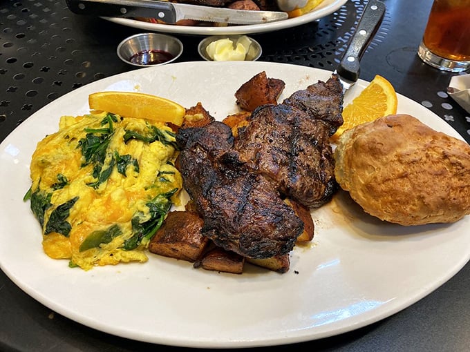 This isn't just steak and eggs—it's a carnivore's dream come true, with perfectly grilled flat iron steak and spinach-flecked scrambled eggs.