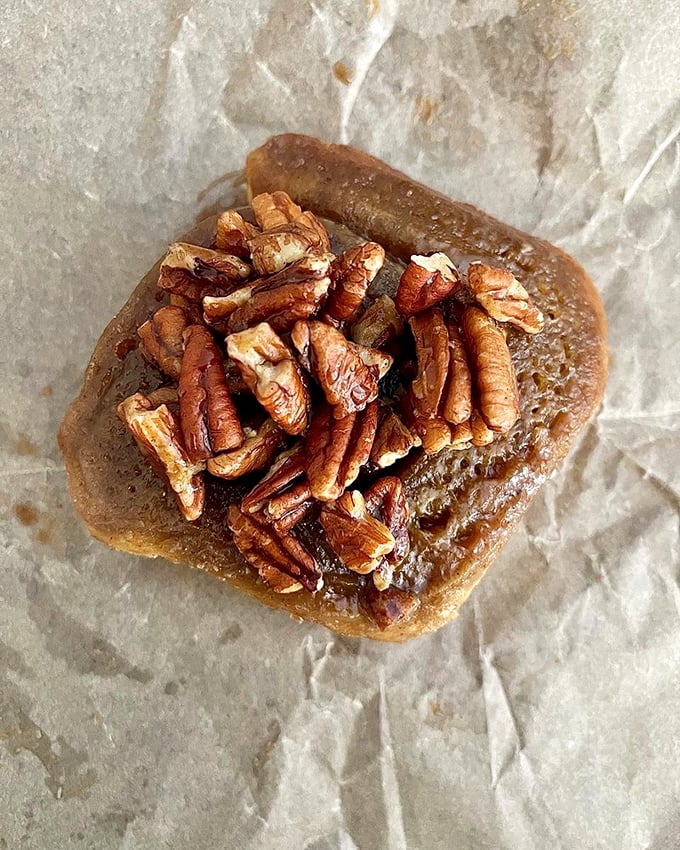 Meet the sticky bun that launched a thousand return visits. Those toasted pecans aren't just a topping—they're a crown befitting pastry royalty.
