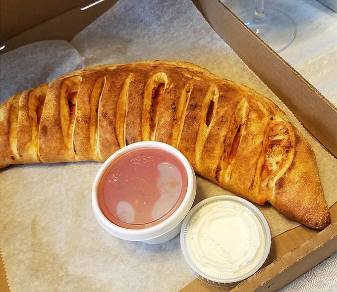 Behold the legendary stromboli in its natural habitat—golden, glistening, and ready to make your taste buds write thank-you notes.