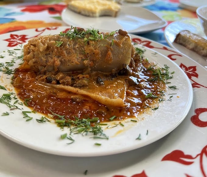 Behold the holupki in all its glory! This stuffed cabbage isn't just food – it's edible architecture with a sauce that demands to be sopped up.