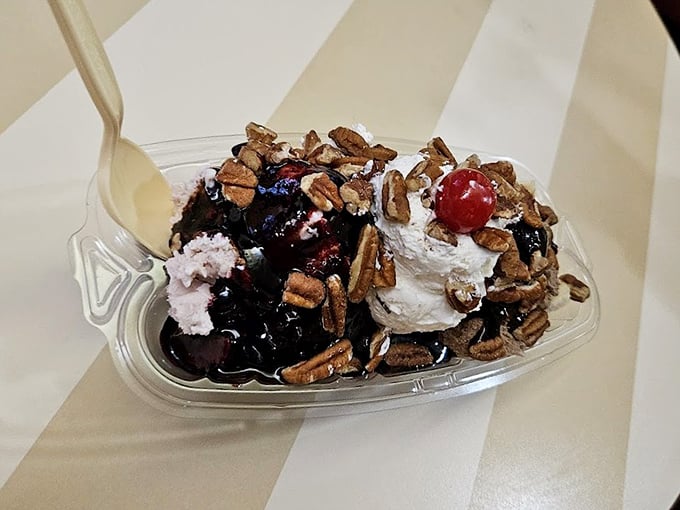A turtle sundae that makes you question why we bother with main courses—pecans, hot fudge, and whipped cream in perfect harmony.