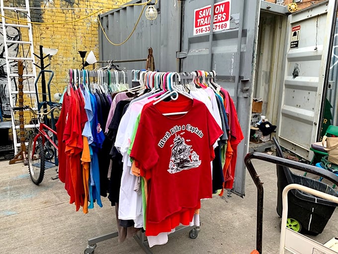 Vintage tees hanging against industrial shipping containers – the perfect Brooklyn juxtaposition of nostalgia and urban grit.