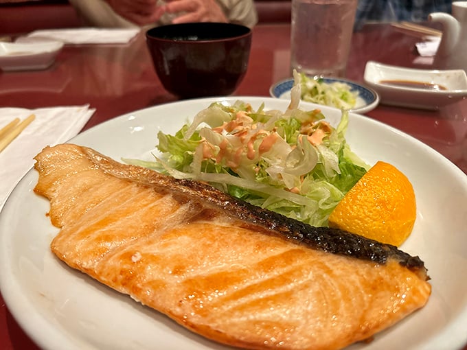 The legendary teriyaki salmon arrives like a sunset on a plate—perfectly caramelized exterior giving way to moist, flaky fish that practically melts on contact.