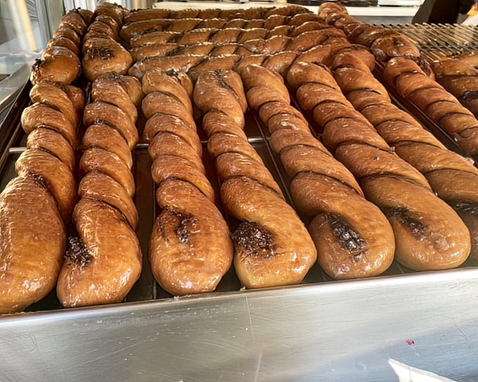 Tiger Tails lined up like edible works of art—twisted, glazed, and glistening with a promise that calories consumed on vacation don't count.